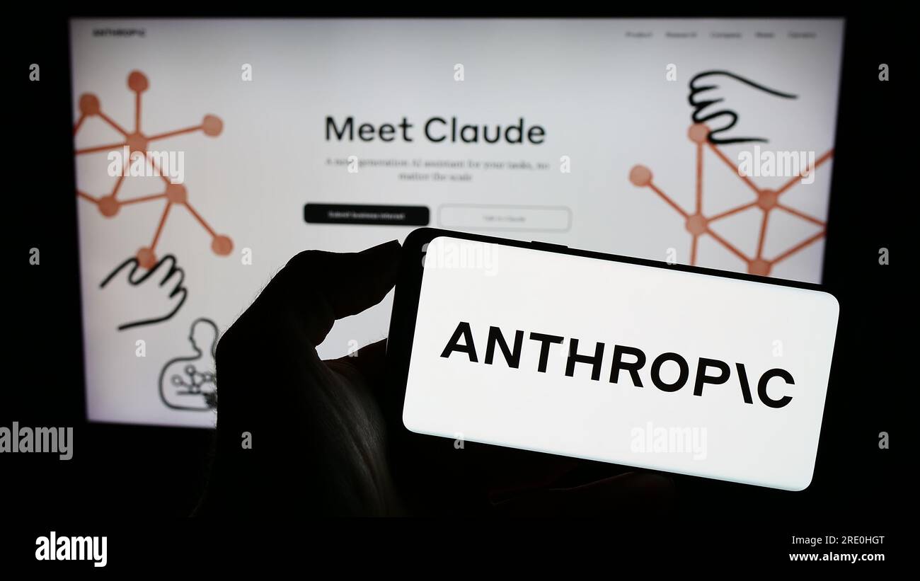 Person holding mobile phone with logo of US artificial intelligence ...