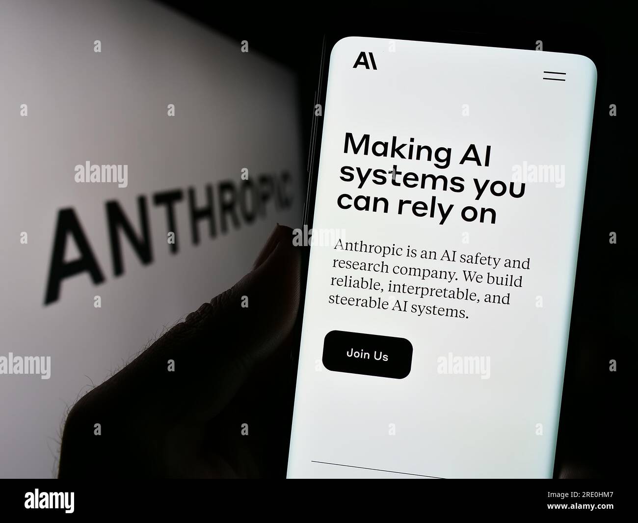 Person holding smartphone with web page of US artificial intelligence ...