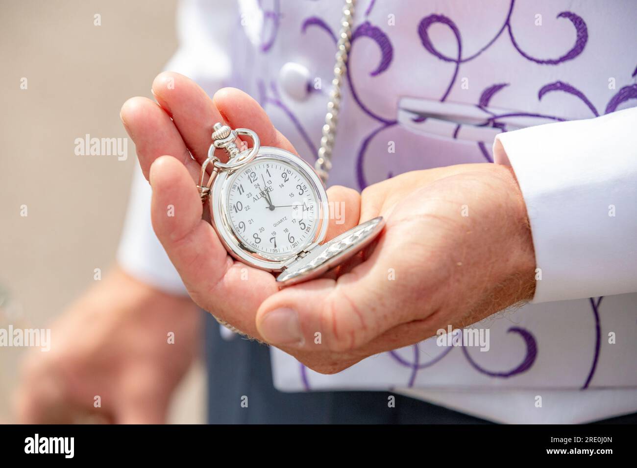 A Groom holding a silver pocket watch in the palm of his hand Stock ...