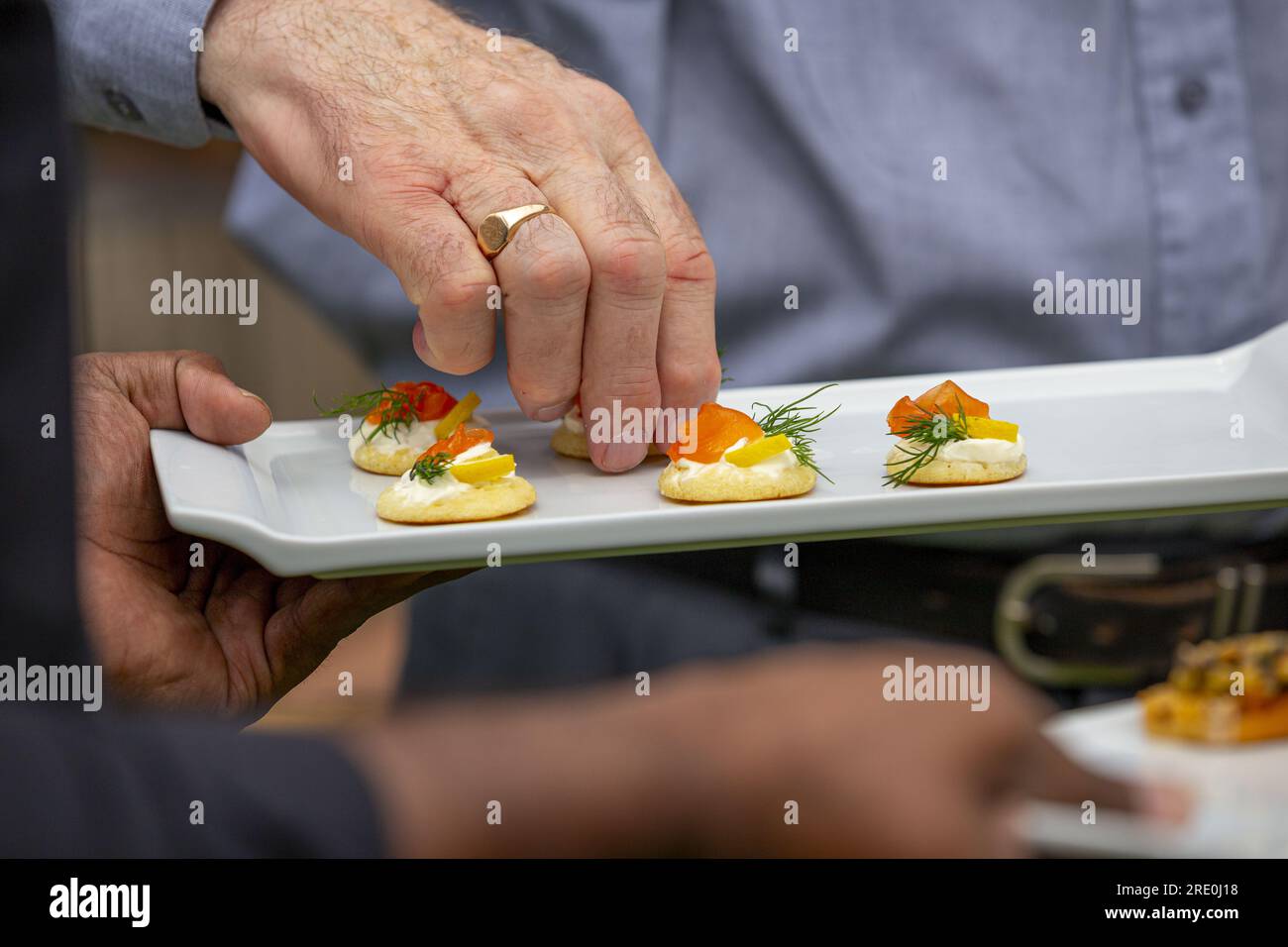 A waiter serving Salmon and Dill canapes at a Wedding reception Stock ...