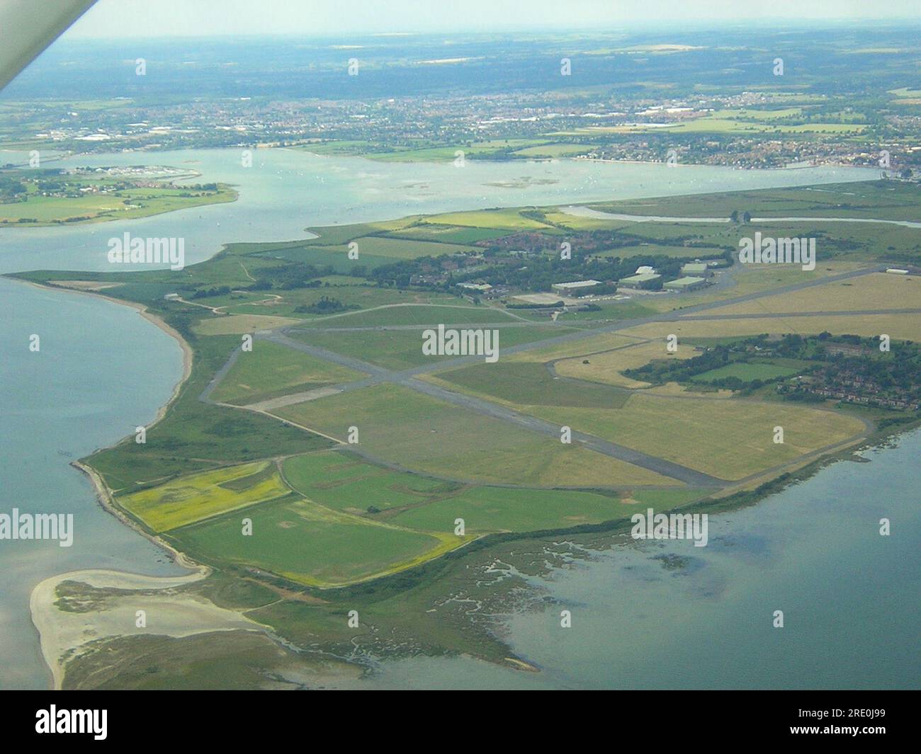 Aerial view looking down on Thorney Island, with runways and hangars of ...