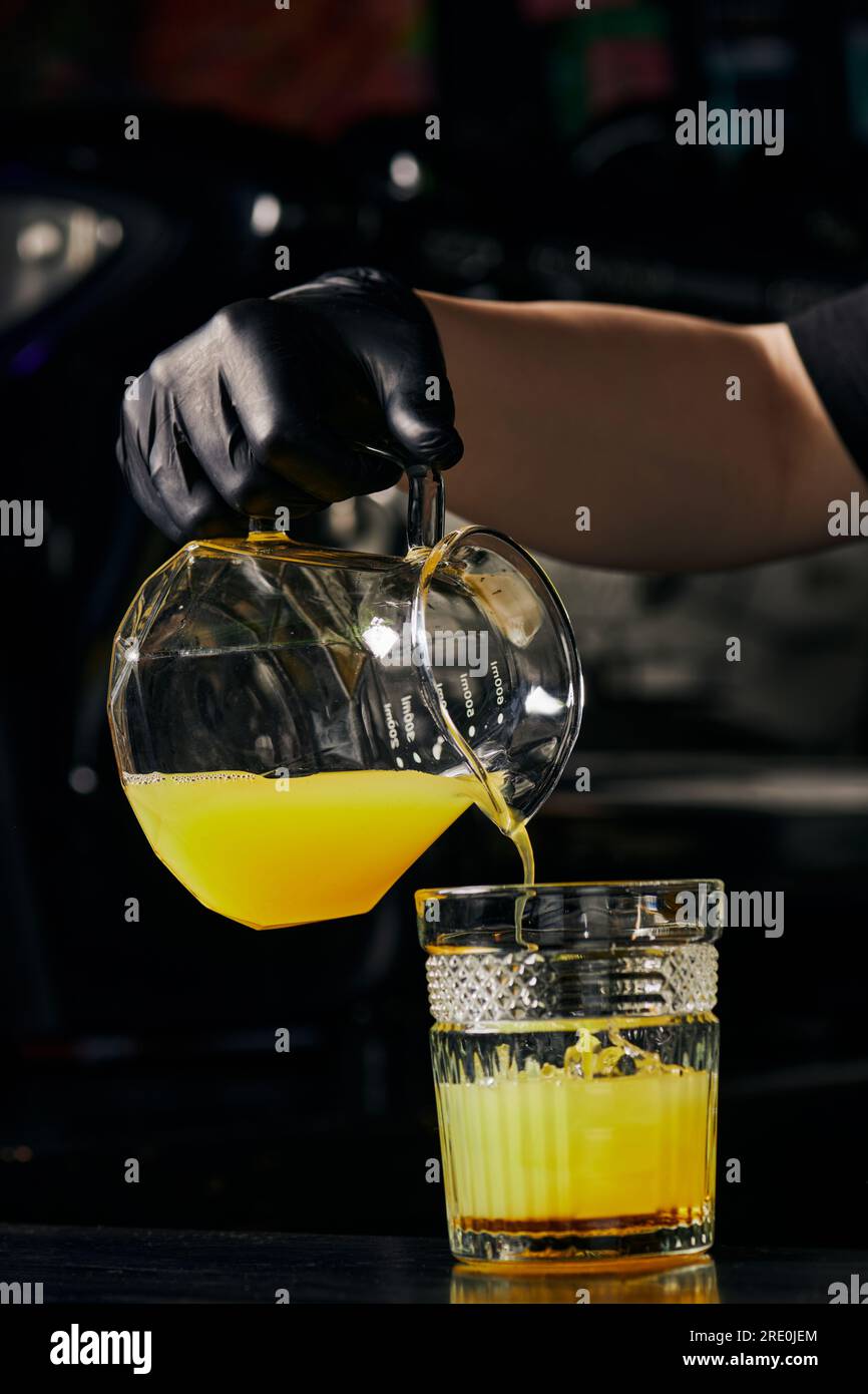 barista making bumblebee, orange juice and espresso, summer drink ...