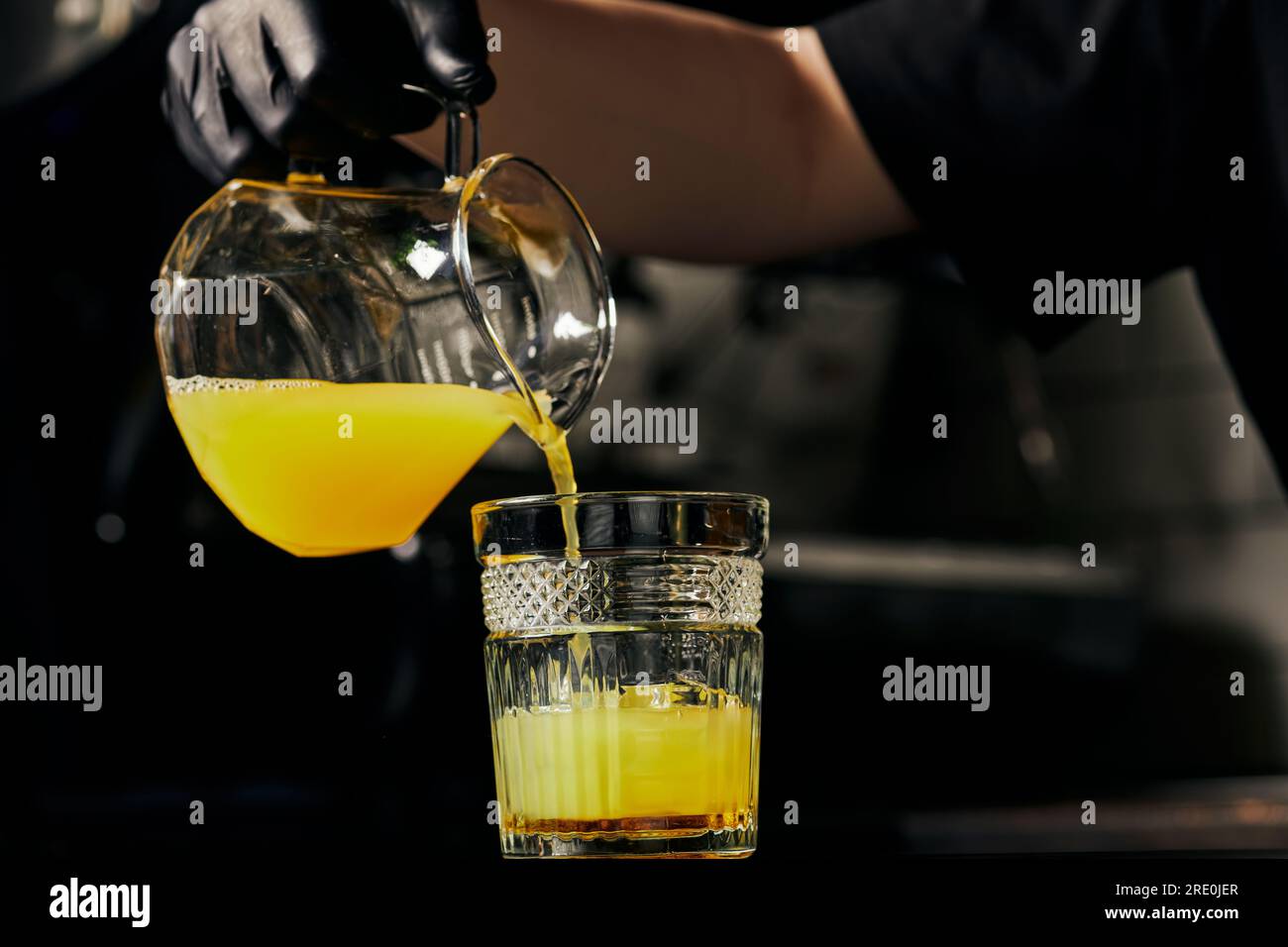 barista preparing bumblebee drink, orange juice and espresso, cold ...