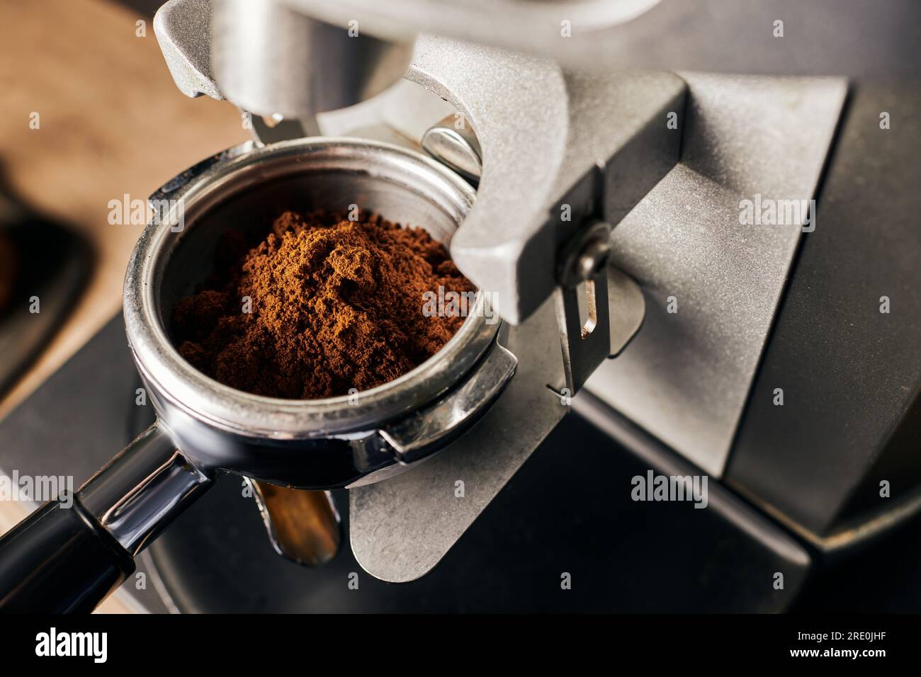 preparation of coffee, close up of grinded coffee beans in portafilter ...