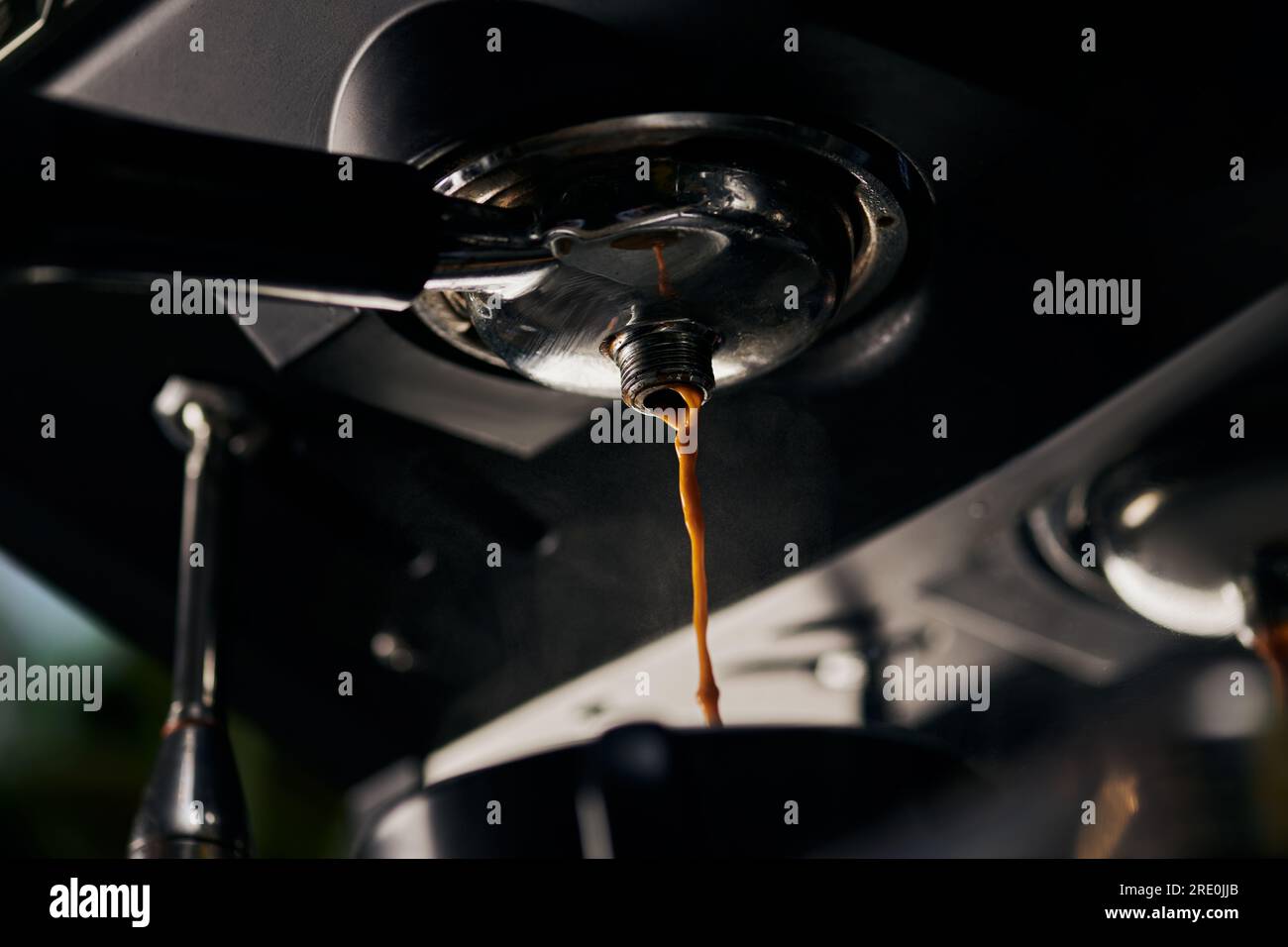 coffee extraction, black coffee, hot espresso dripping into cup ...