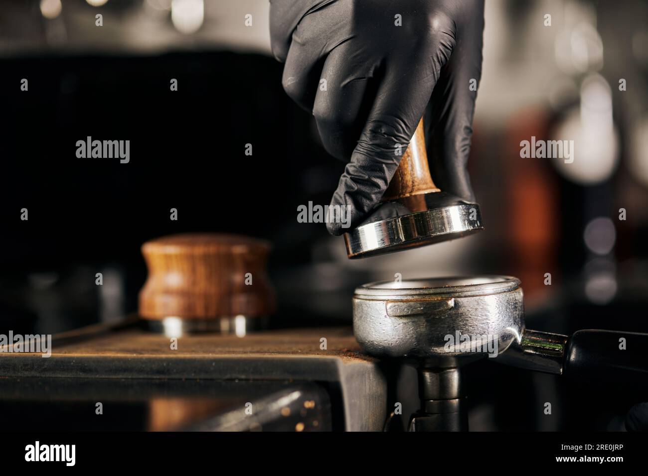 coffee shop, cropped view of barista in black latex glove holding ...