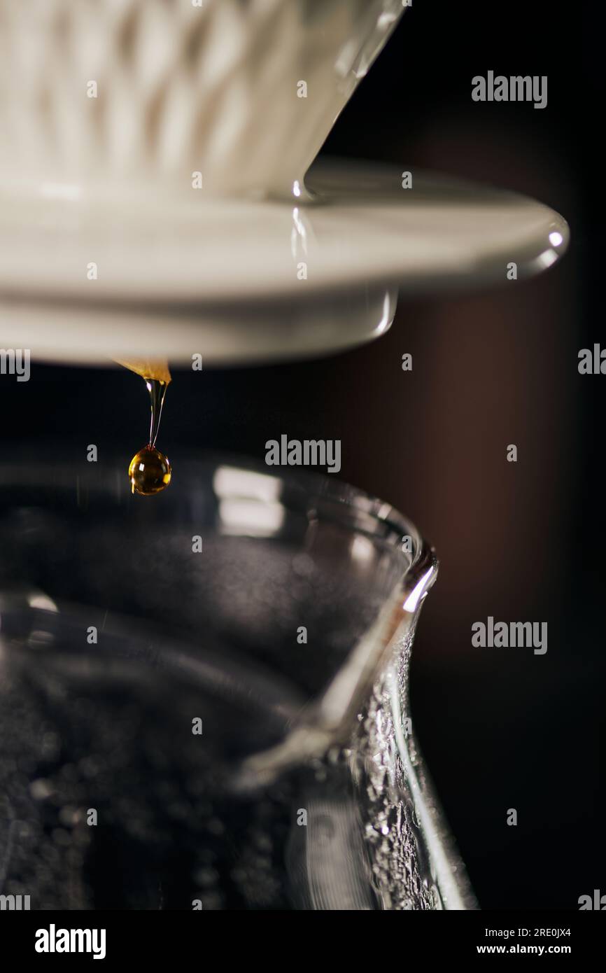 V-60 style espresso, close up view of pour-over coffee dripping from ...