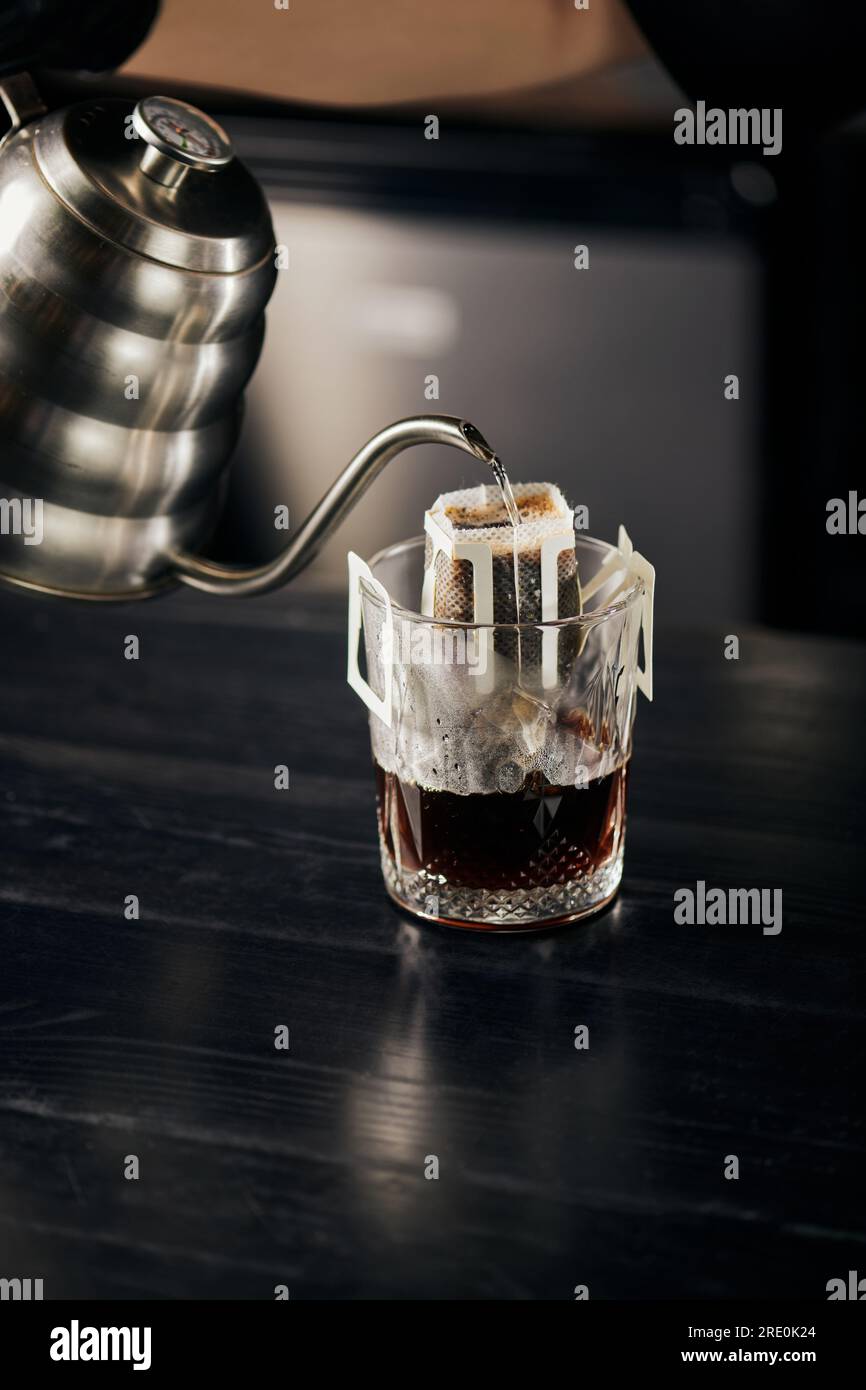 alternative brew, boiling water pouring into glass with coffee in ...