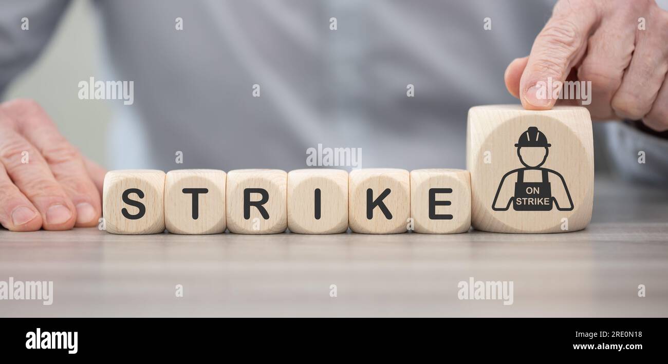 Wooden blocks with symbol of strike concept Stock Photo - Alamy