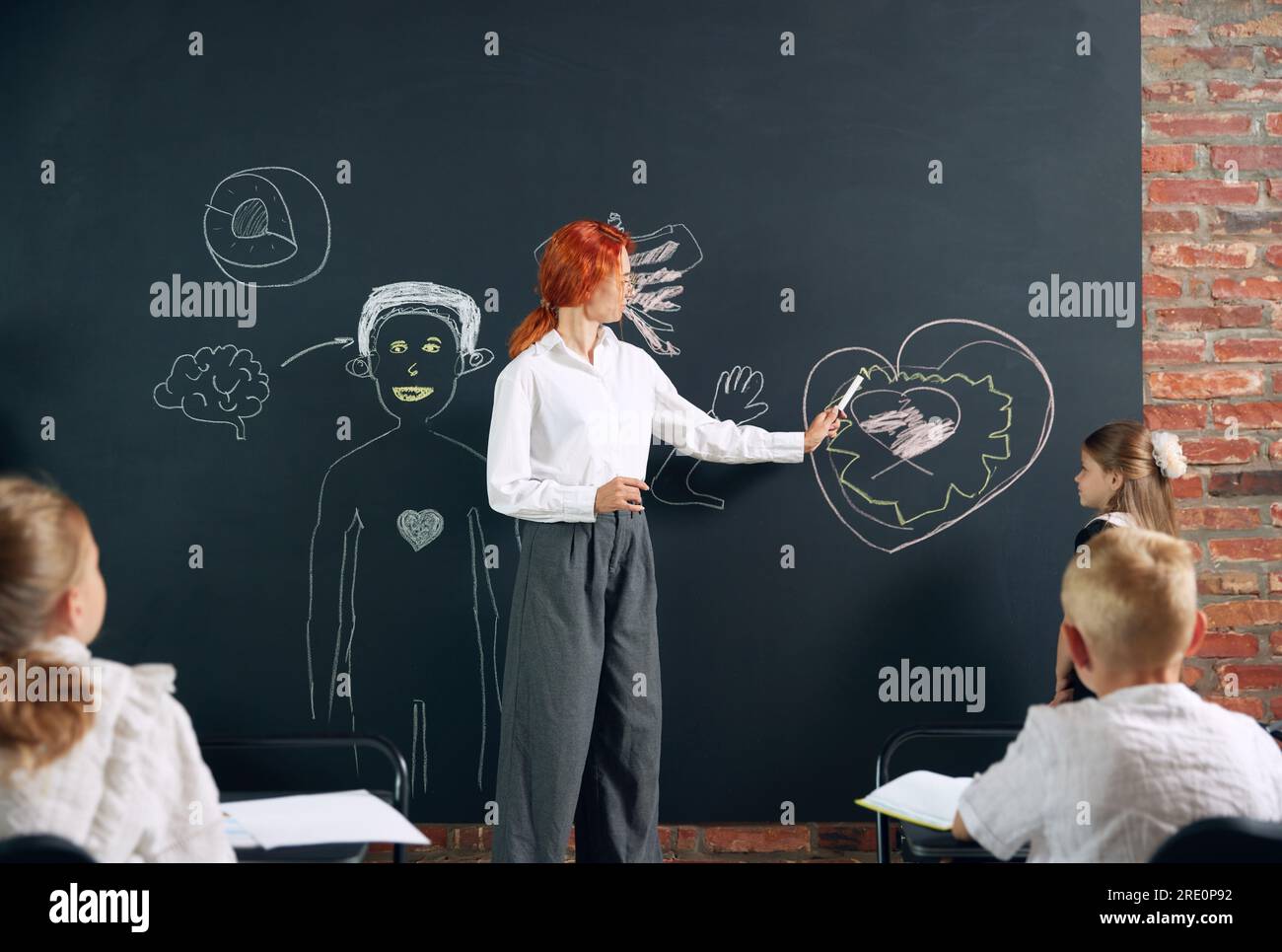 Young woman, teacher teaching anatomy to children in primary school ... Young woman, teacher teaching anatomy to children in primary school ...