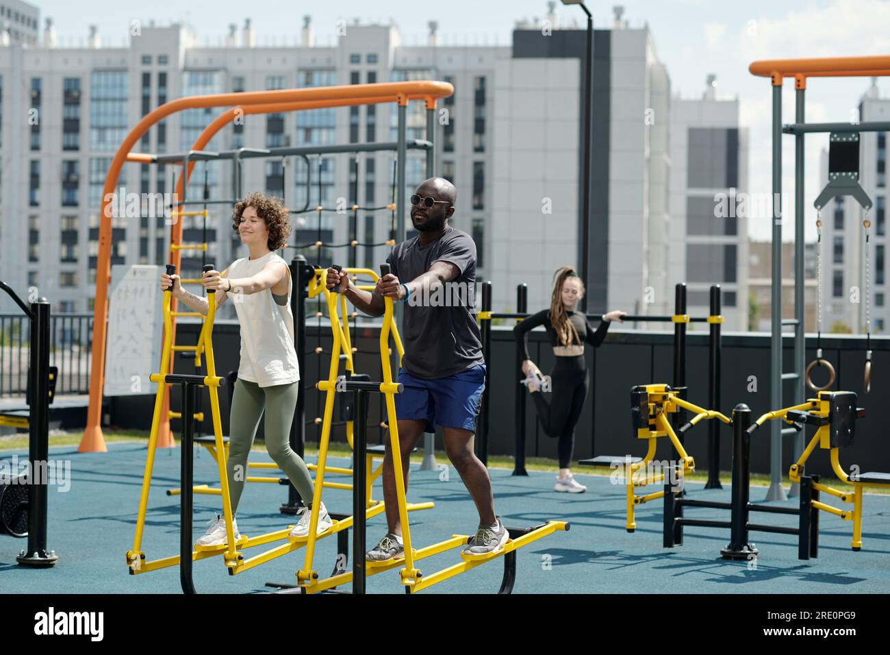 Young African American man and group of sportswomen in activewear ...