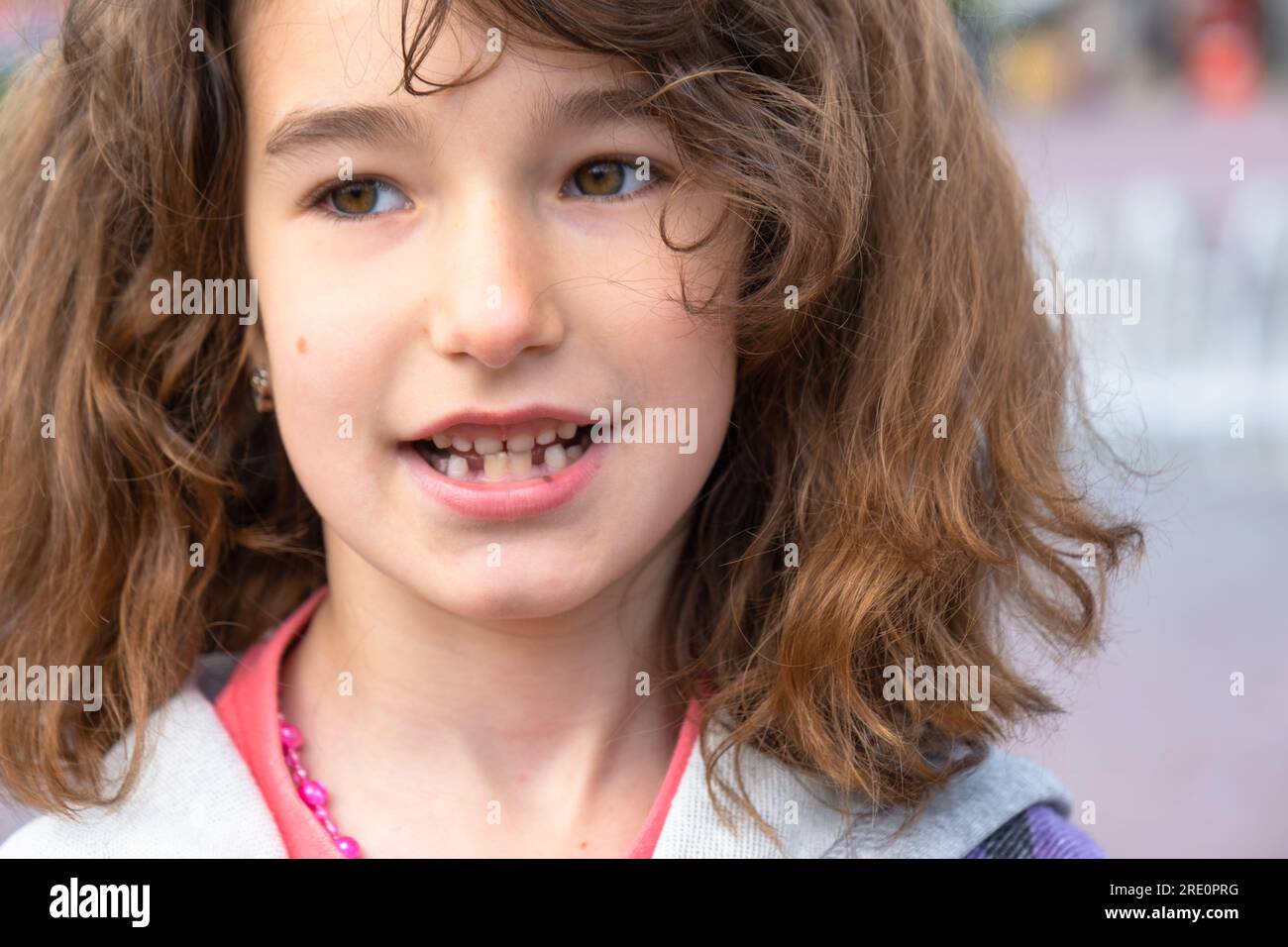 Toothless happy smile of a girl with a fallen lower milk tooth close-up ...
