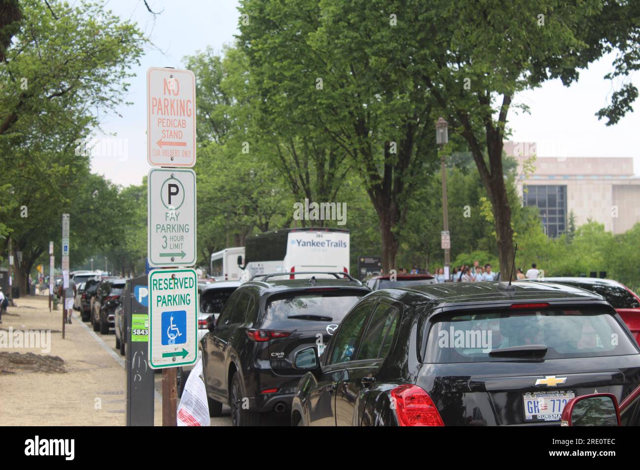 A photo of signs by a road instructing drivers where and how to park ...