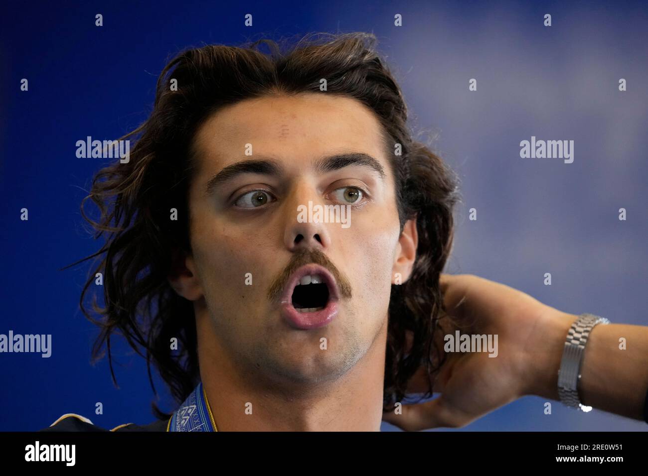 Thomas Ceccon of Italy reacts after receiving his gold medal for winning the men's 50m butterfly ...