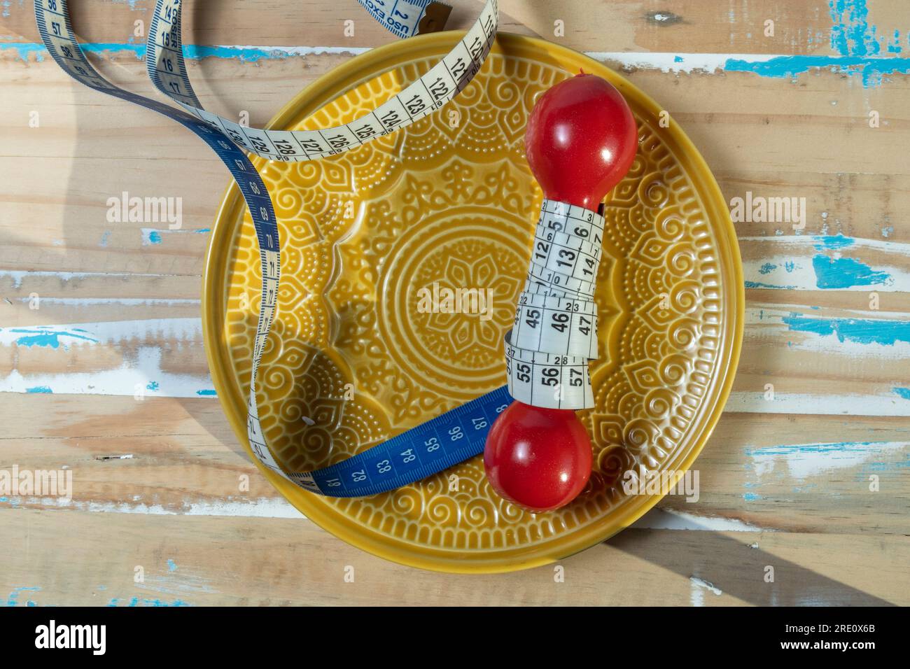 plate of food with an exercise weight inside symbolizing physical ...