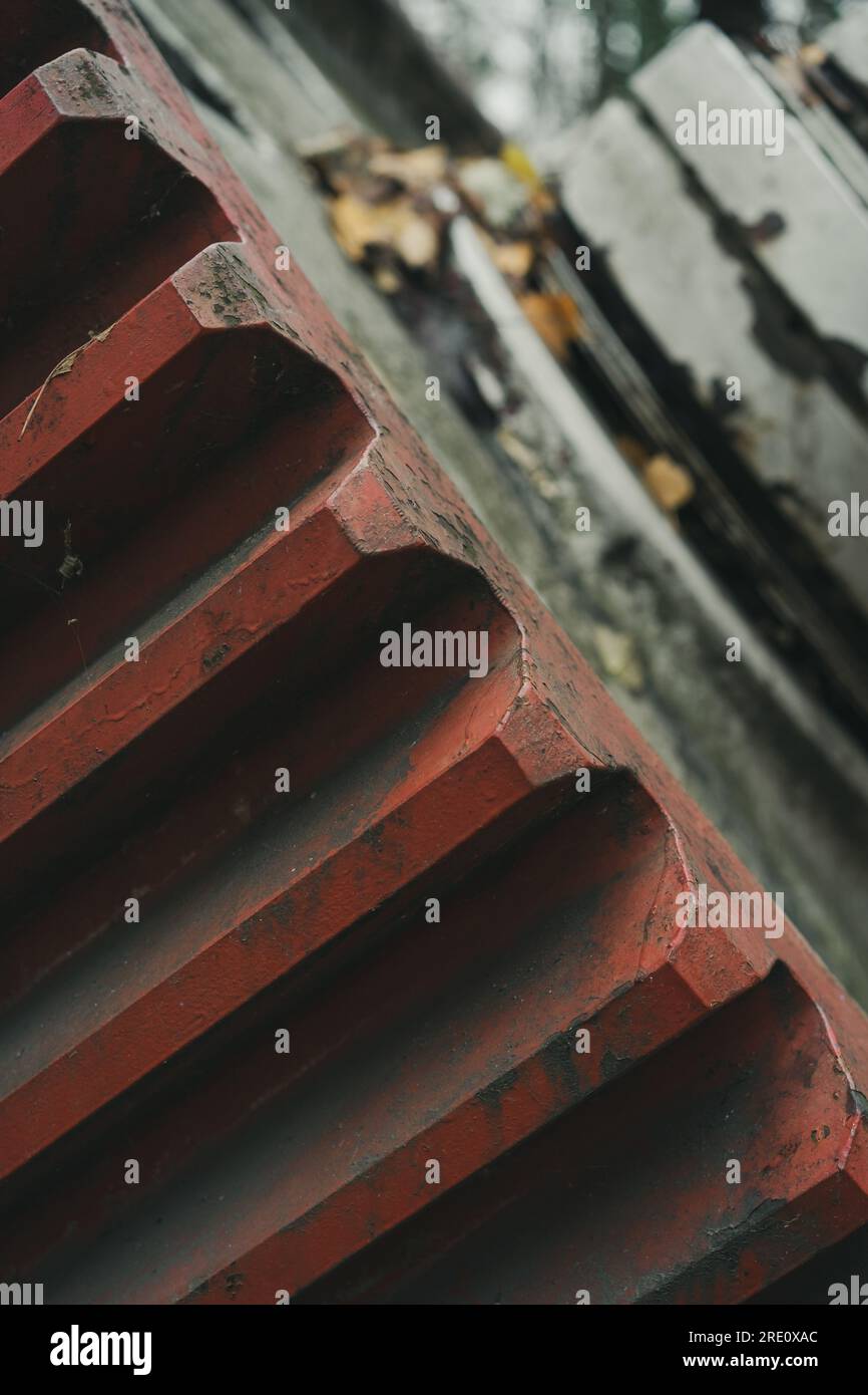 Detail of an old unused red gear. Industrial history machine. Close up ...
