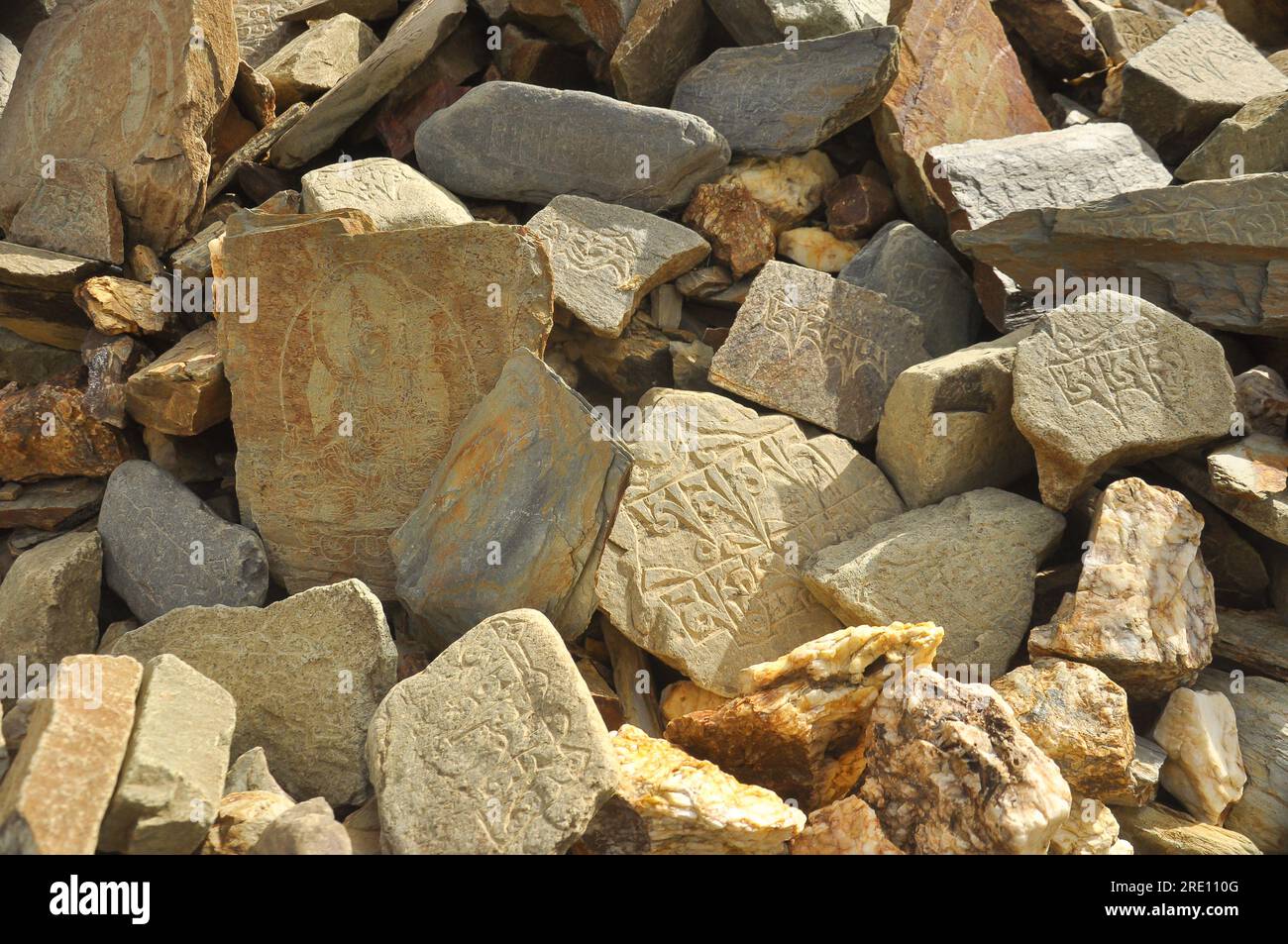 Engraved stones with Tibetan Buddhist mantra in a village of Padum ...