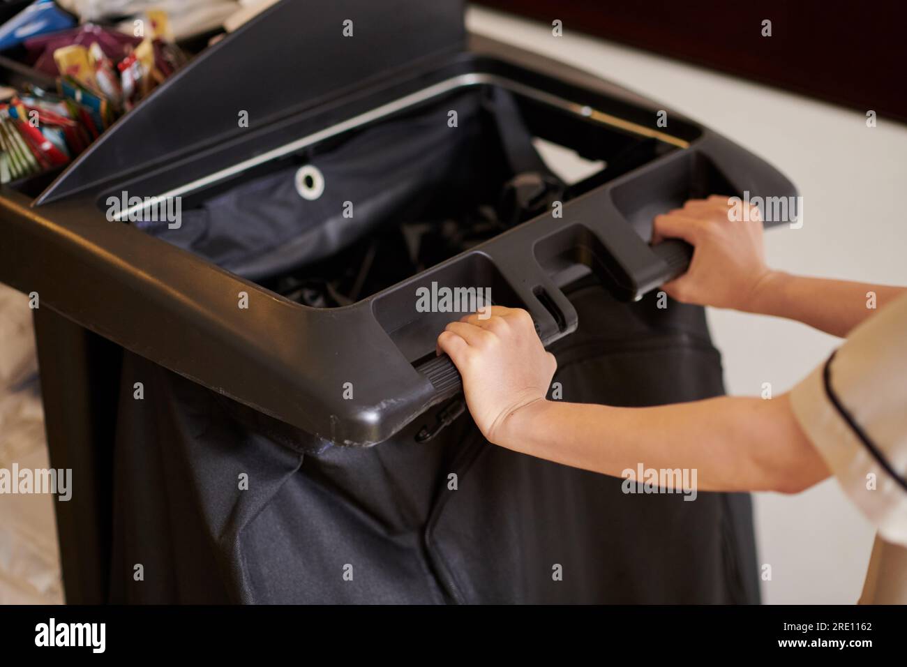 Hands of hotel maid pushing cart with dirty linen Stock Photo - Alamy