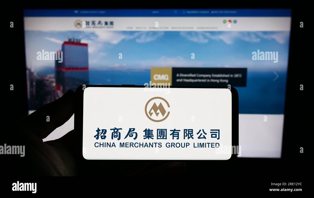 Person holding smartphone with logo of shipping company China Merchants ...