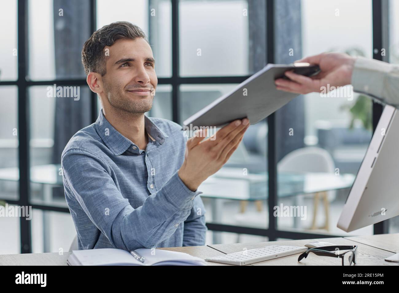 Focus on male hands passing each other folder with papers Stock Photo ...