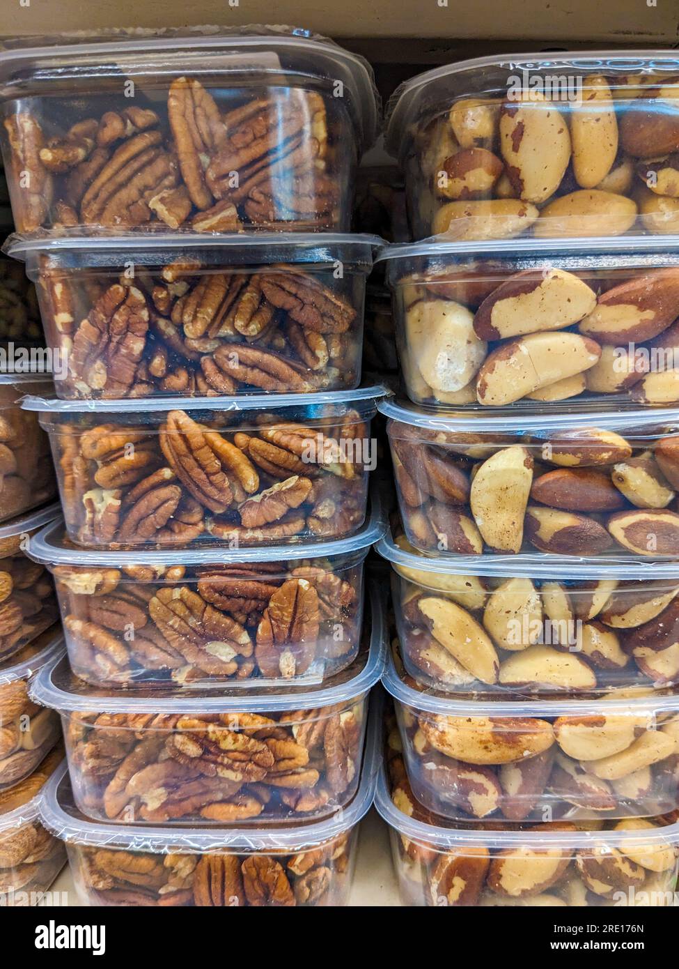 Walnuts and Brazil nuts in plastic containers in the supermarket Stock ...