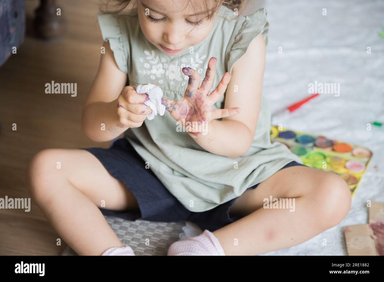 Very cute child cleaning his hands after having been playing with ...