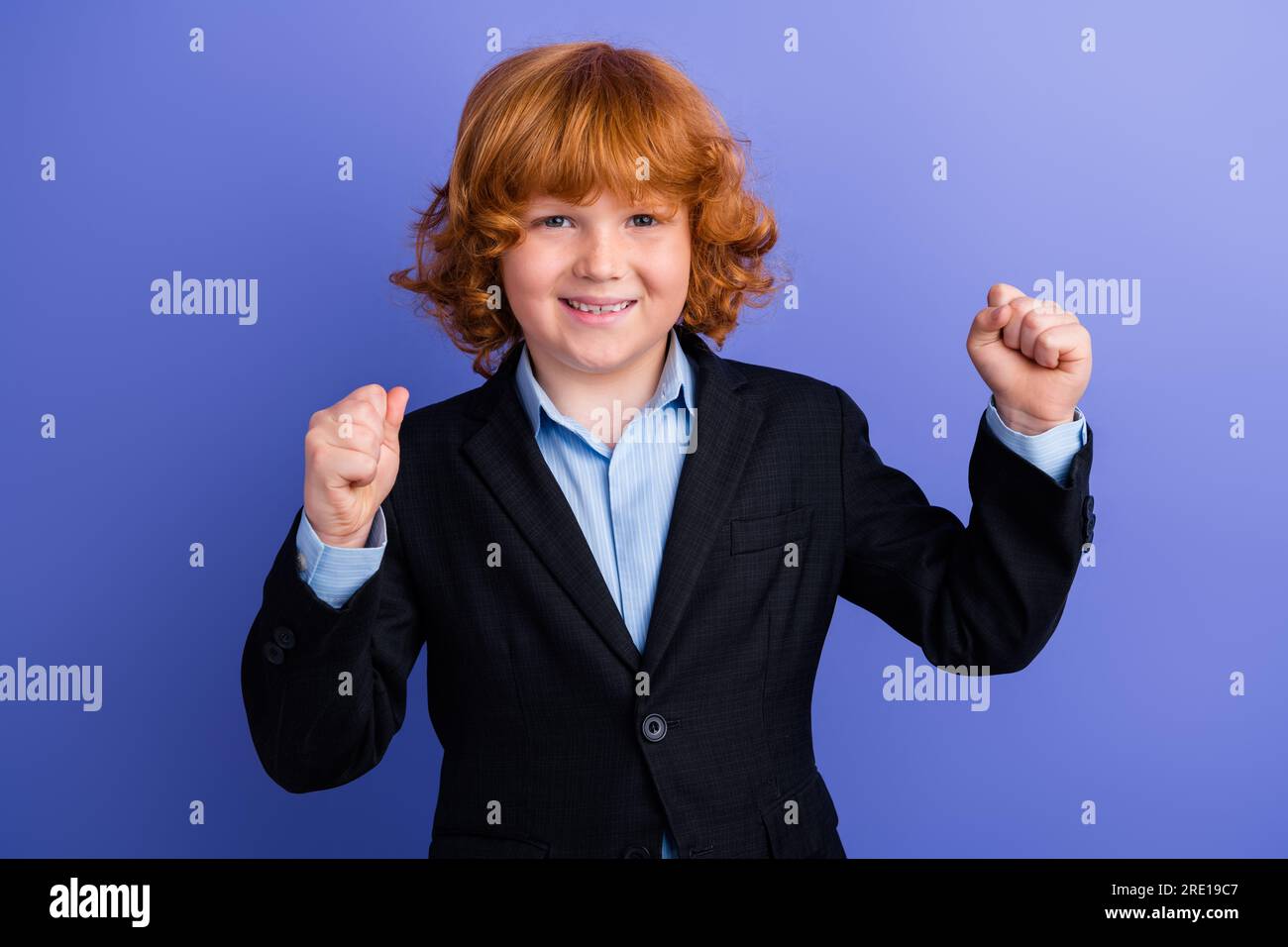 Photo of delighted positive small boy toothy smile raise fists ...