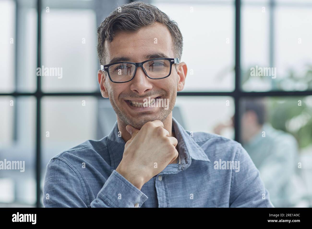 Difficult choice. Embarrassed young man sitting at a table in the ...