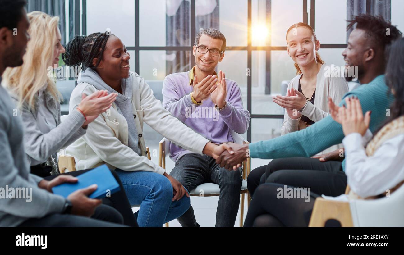 t. Multiethnic group therapy friends giving handshakes on meeting ...