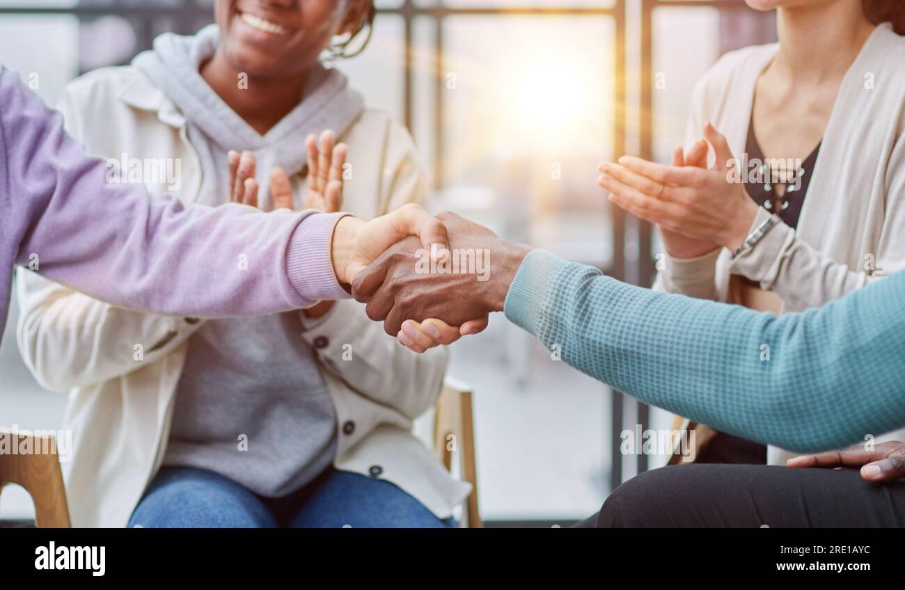 close up. smiling guy shaking hands with his friend Stock Photo - Alamy