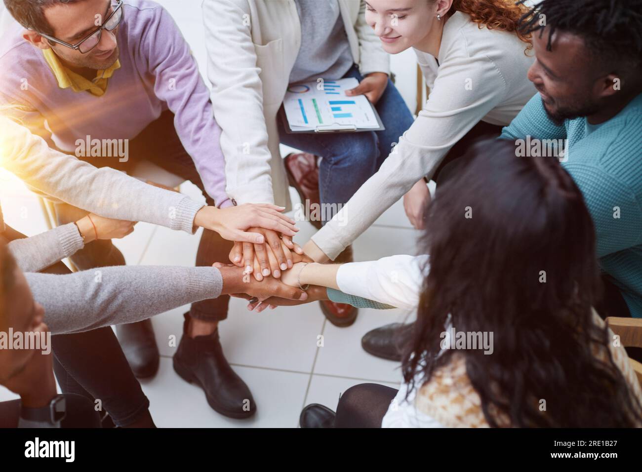 close-up of a business team sitting holding hands Stock Photo - Alamy