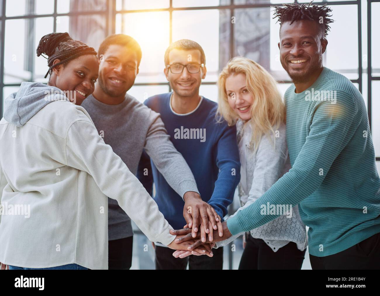 Partners putting their hands on top of each other at workplace Stock ...