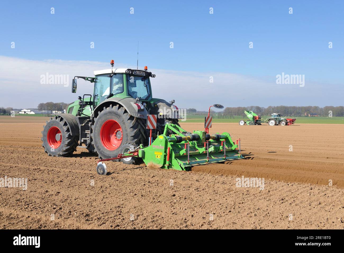 Potato planting, mechanized sowing with tractor and passage of the ...