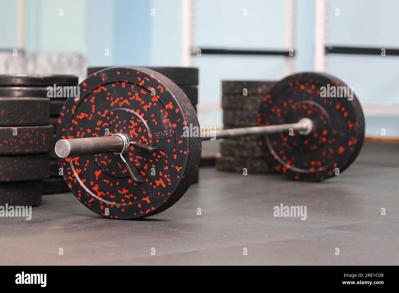 Barbell with plates in the gym room Stock Photo - Alamy