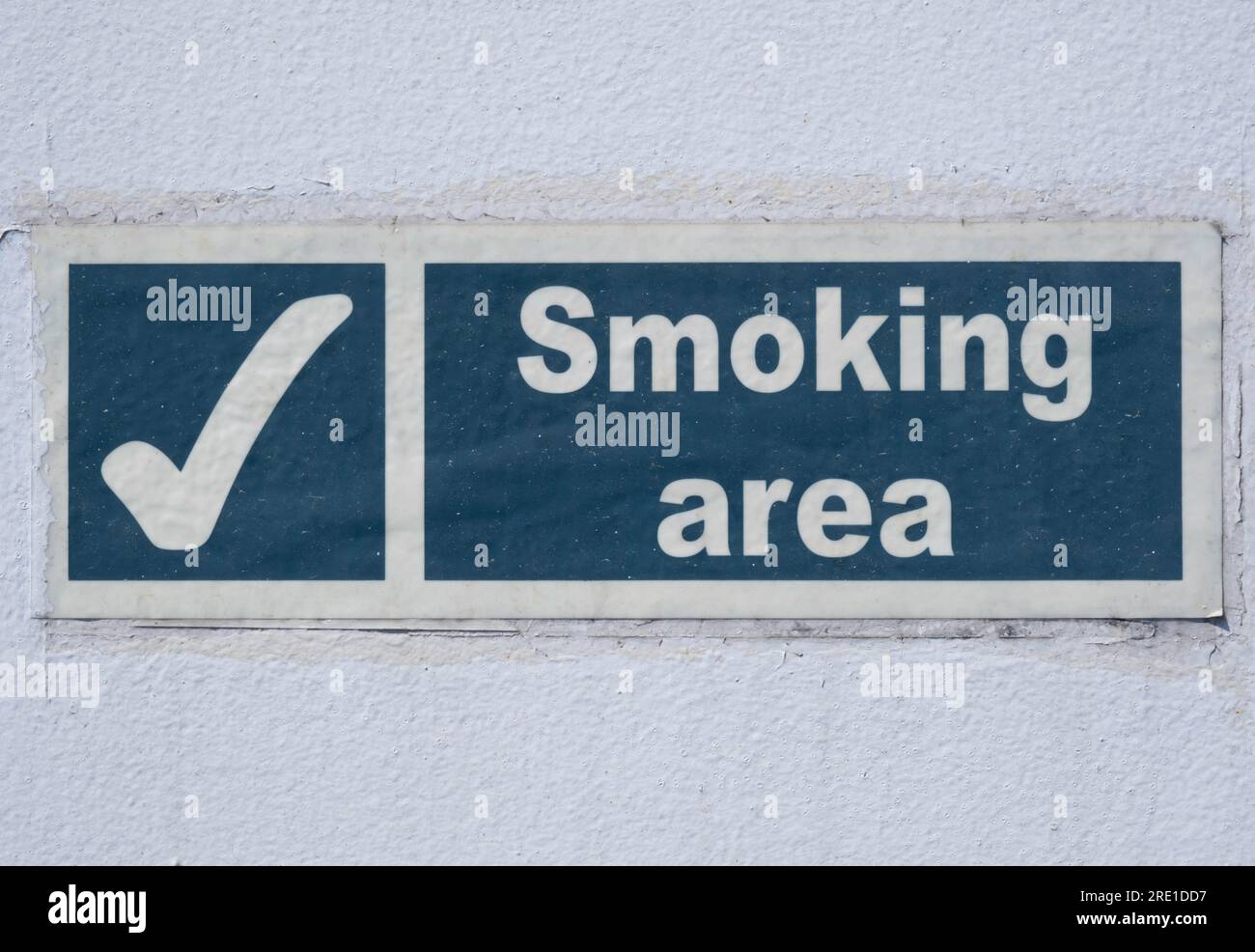 Weathered sticker 'Smoking Area' with OK sign, affixed to the white ...