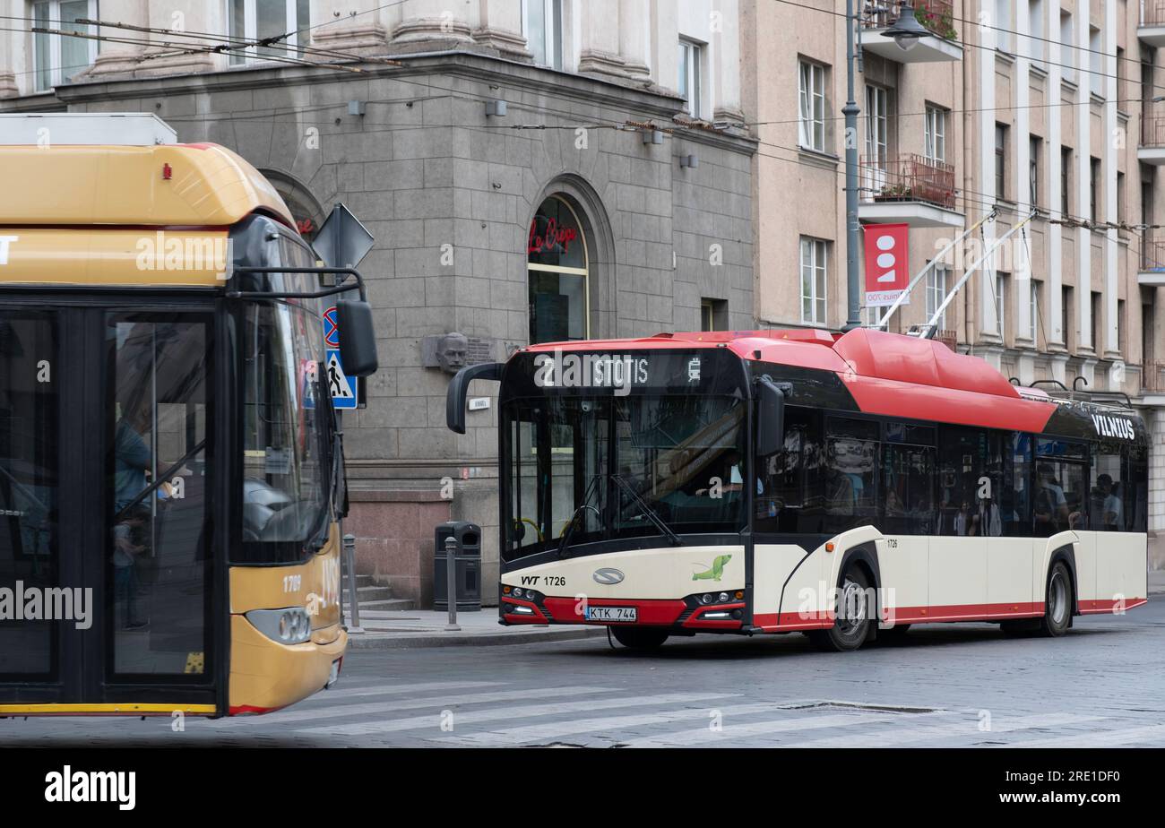 Two buses pass each other on a street in in the center of Vilnius, Lithuania. Public Transport ...