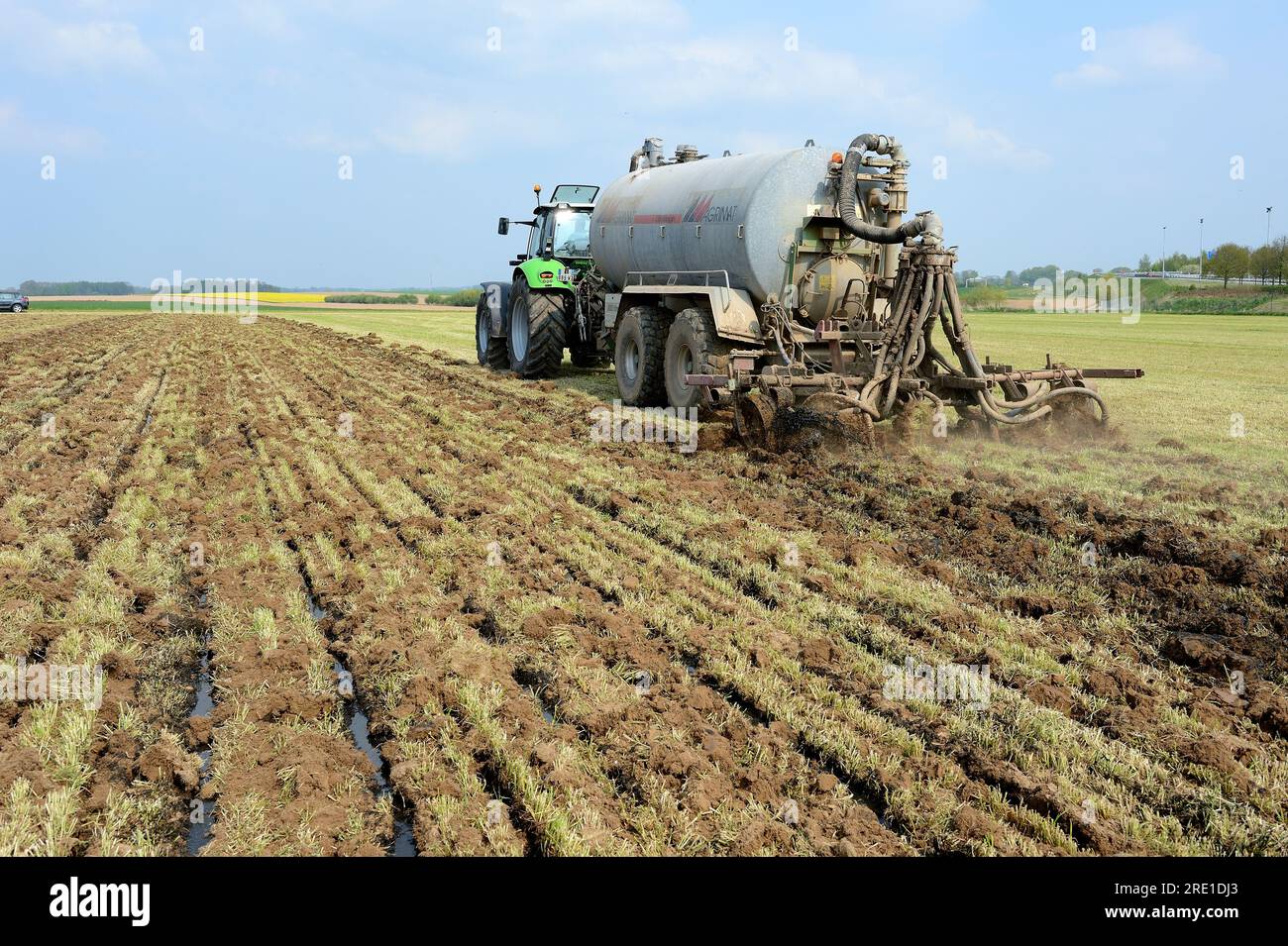 Spreading liquid manure on a recently mown ryegrass field, using a ...