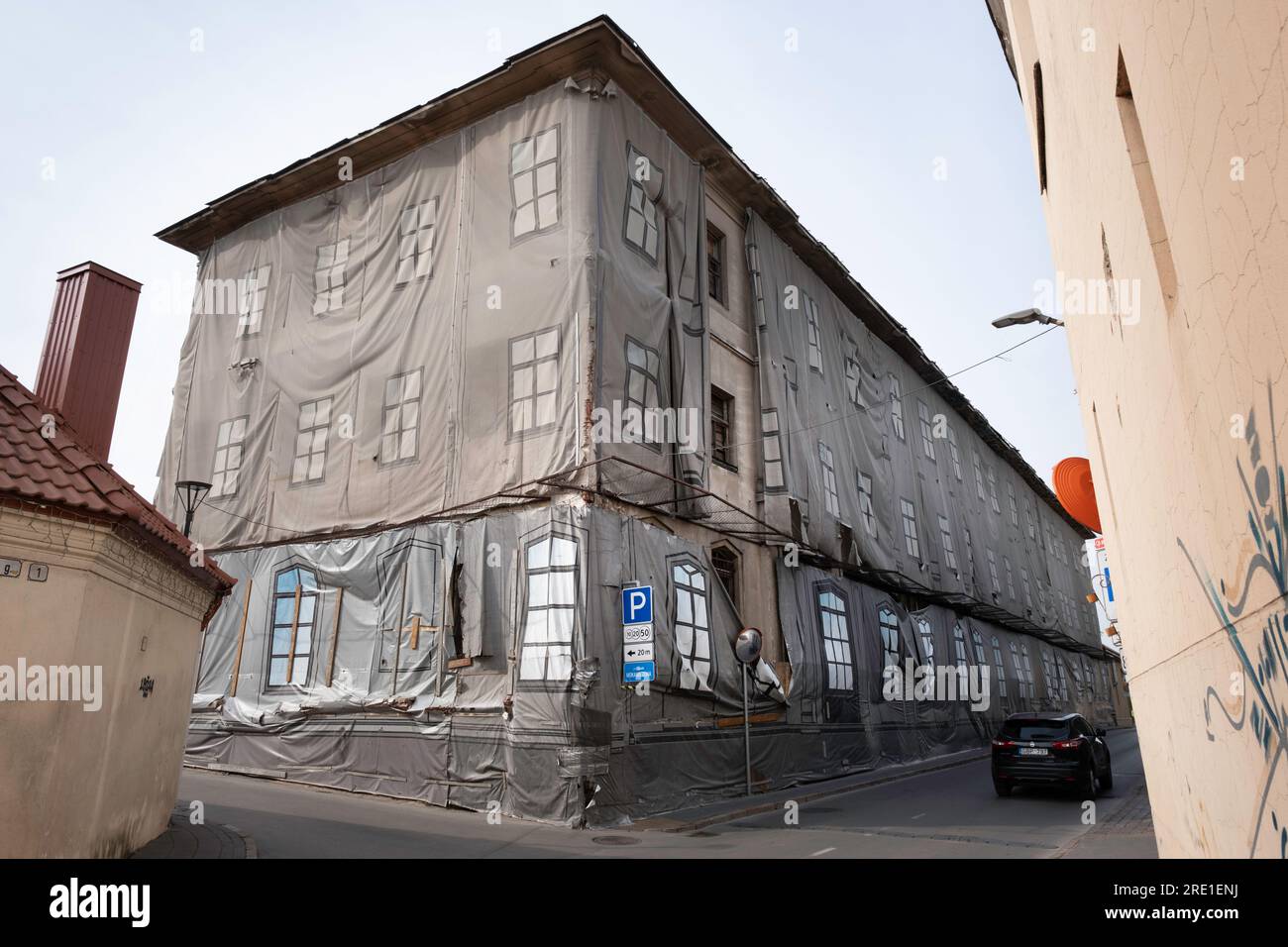 Derelict building wrapped in a window-painted canvas awaiting ...