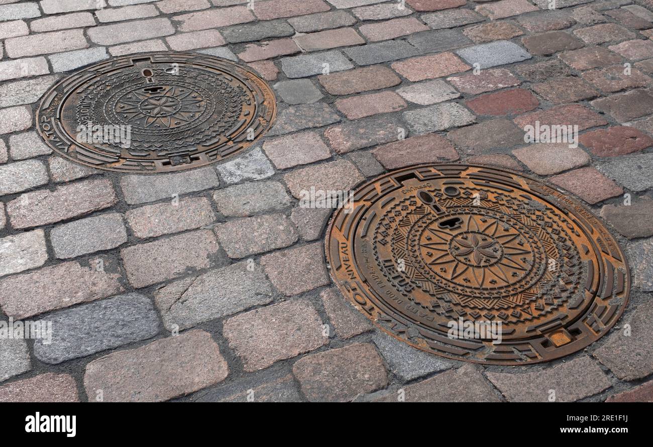 Two decorated manhole covers in a street in the Lithuanian town of ...