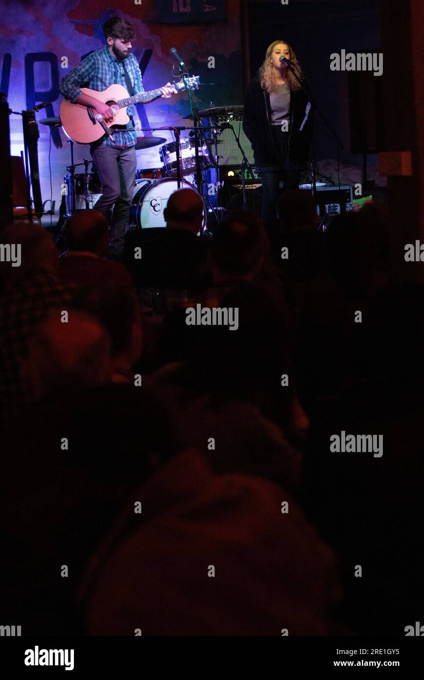 Young singer Ella Spencer with a guitarist at the Maverick Thanksgiving ...