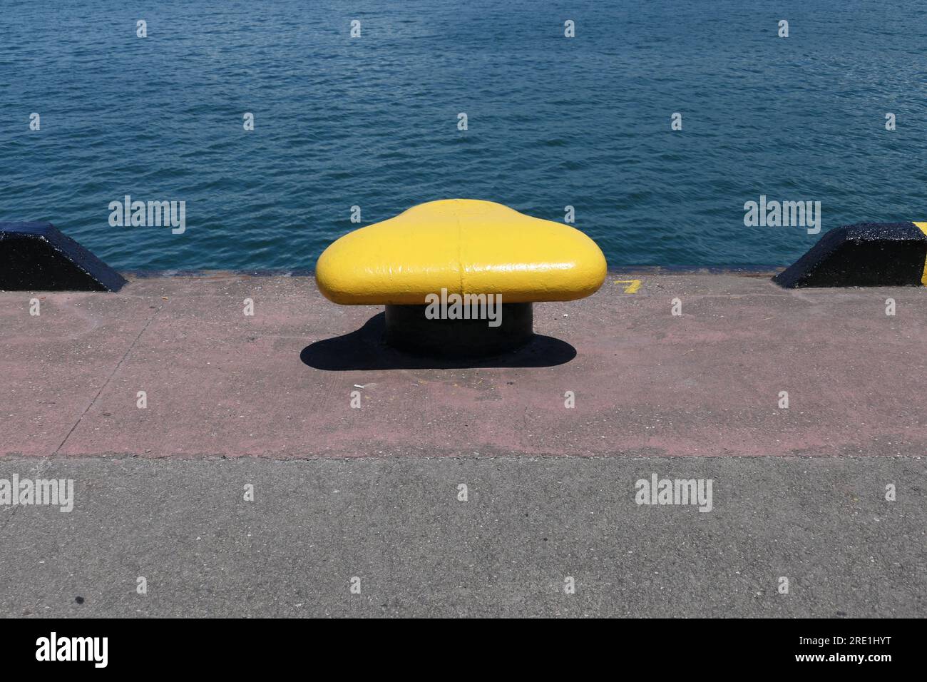 Yellow mooring bollard at the port Stock Photo - Alamy