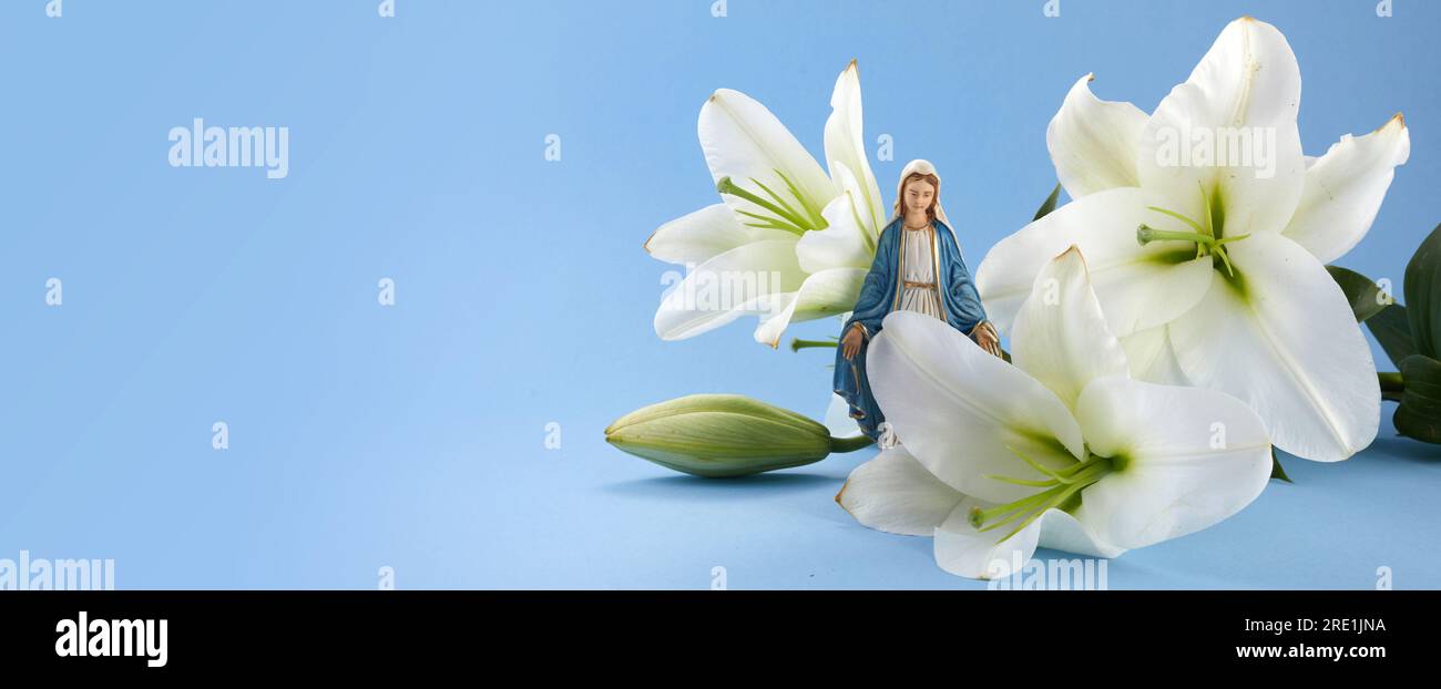 Assumption of Mary day. Virgin Mary figurine with lily flowers Stock ...
