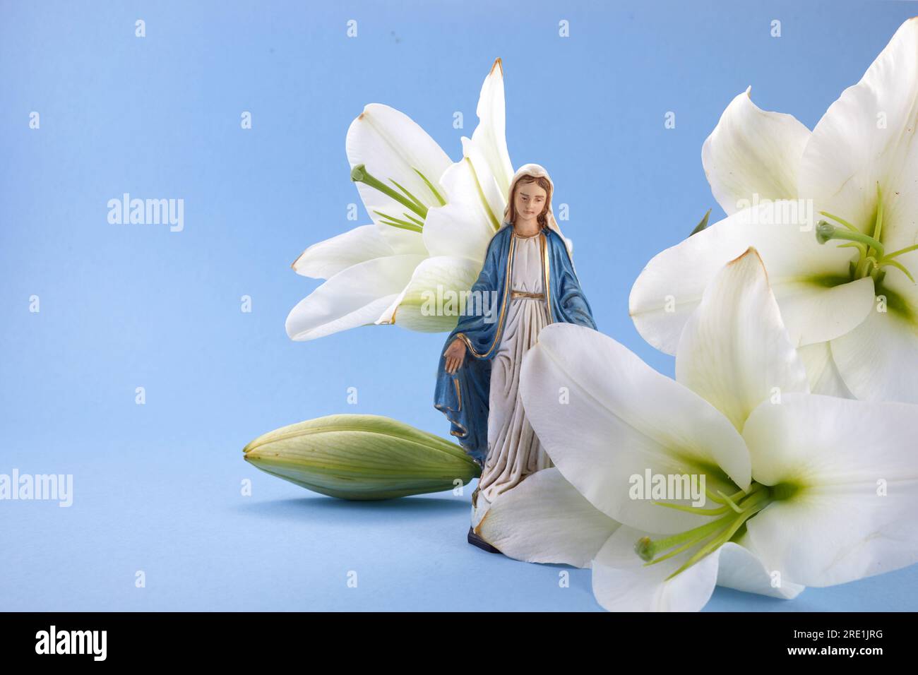 Assumption of Mary day. Virgin Mary figurine with lily flowers Stock ...