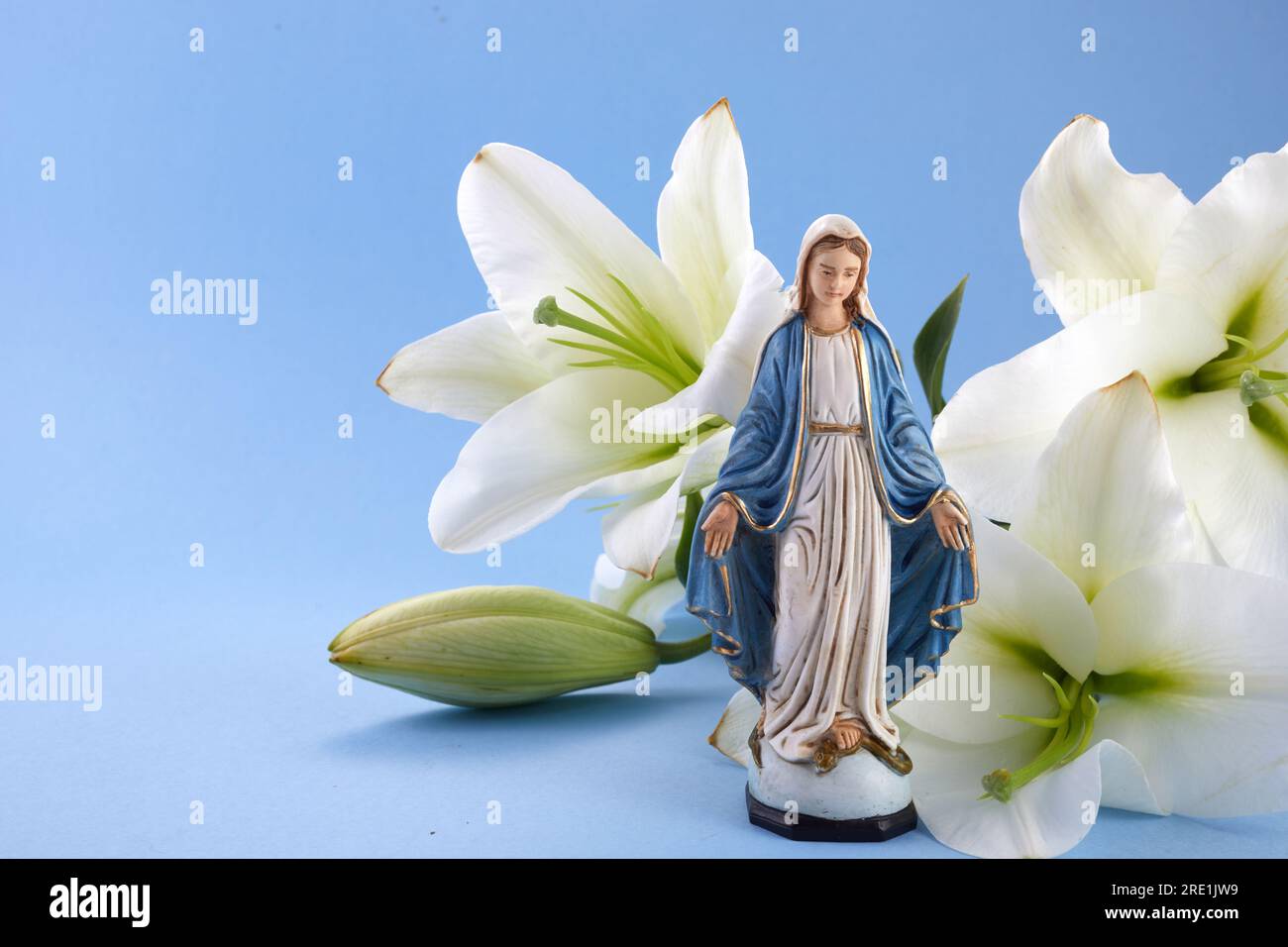 Assumption of Mary day. Virgin Mary figurine with lily flowers Stock ...