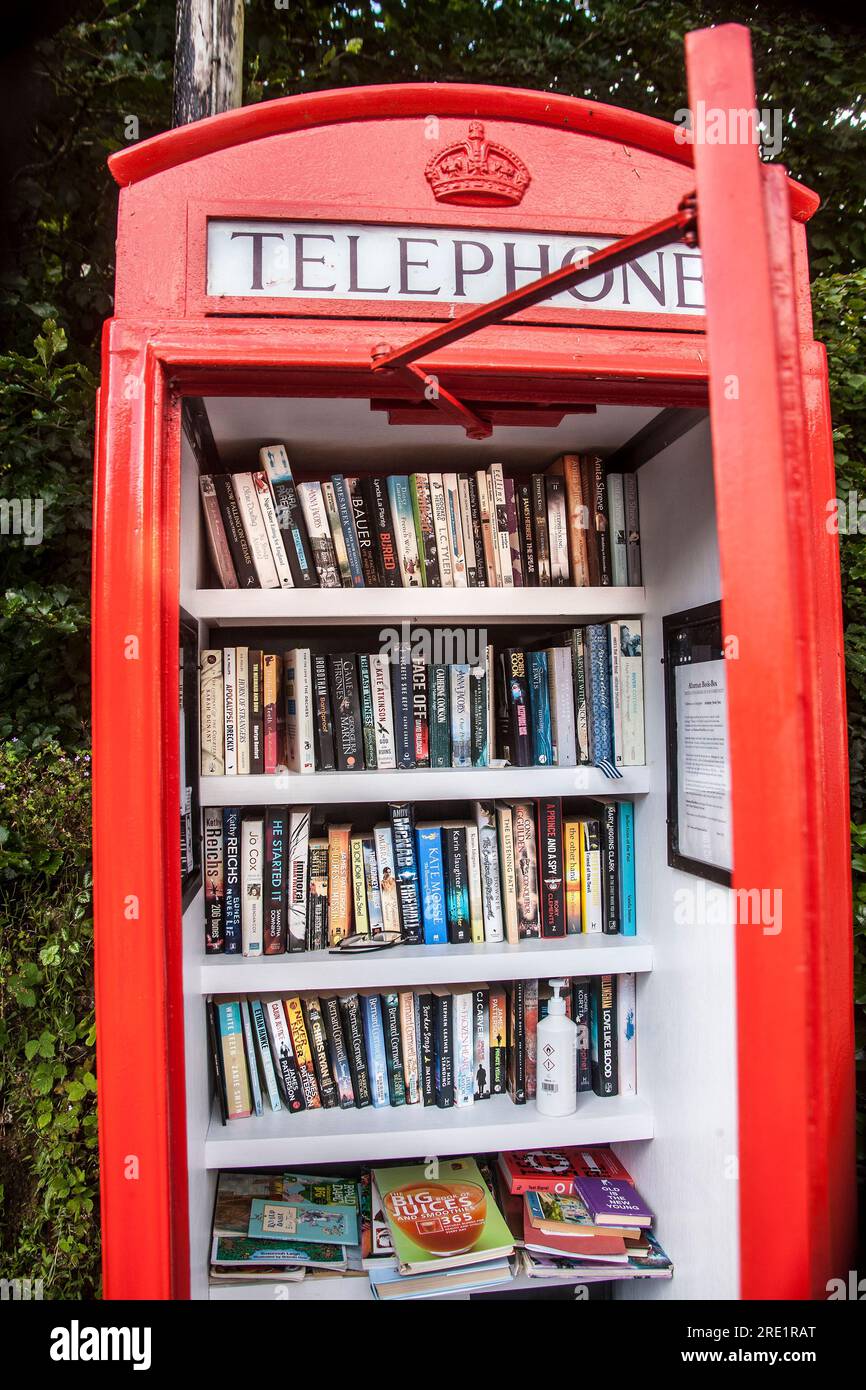 Red British telephone box used as book lending library Stock Photo - Alamy
