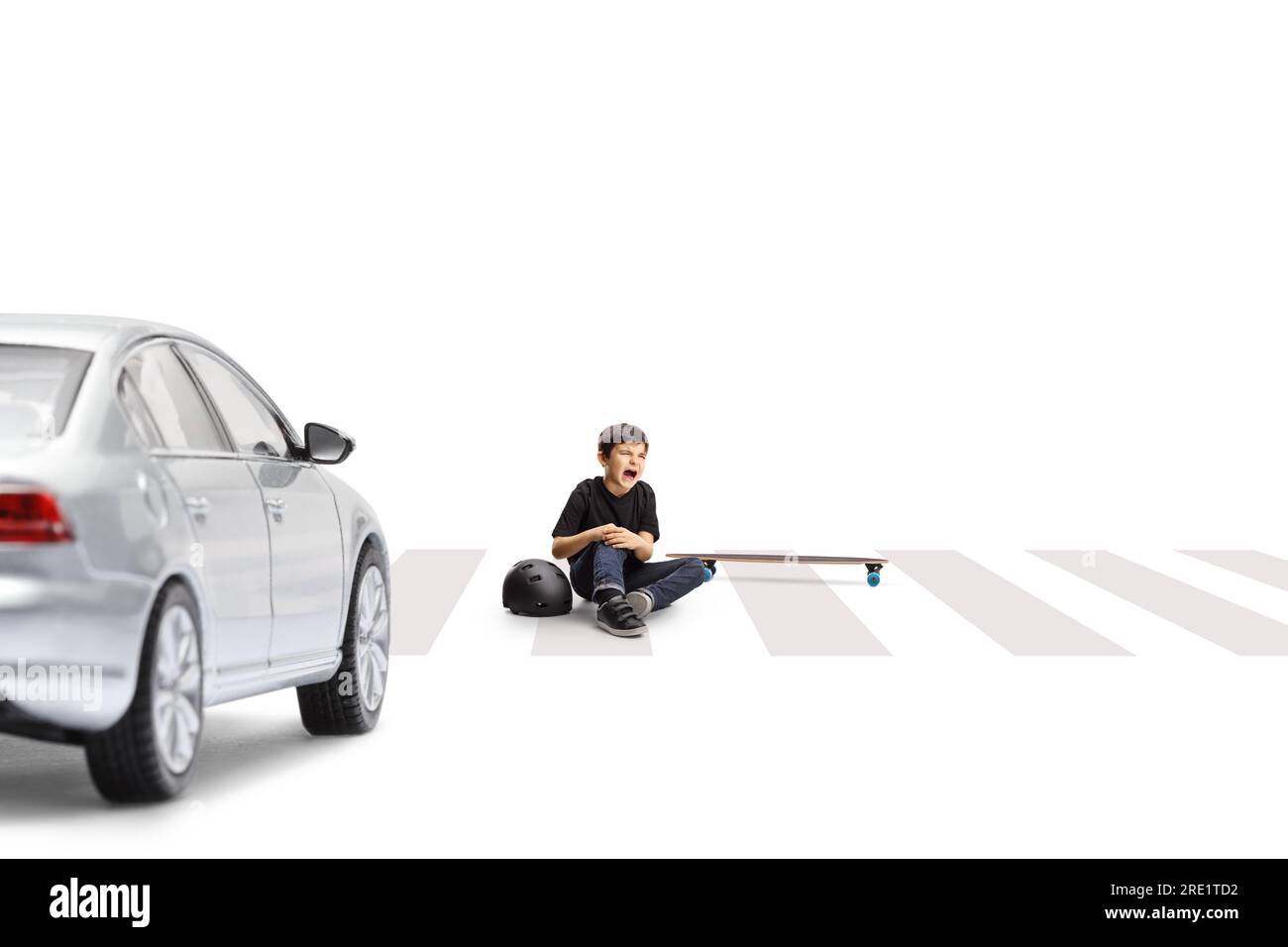 Child with a skateboard sitting on a street and crying in front of a ...