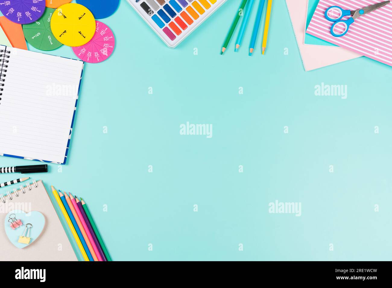 Back to school background. Colored pencils, books, notebooks, pens ...