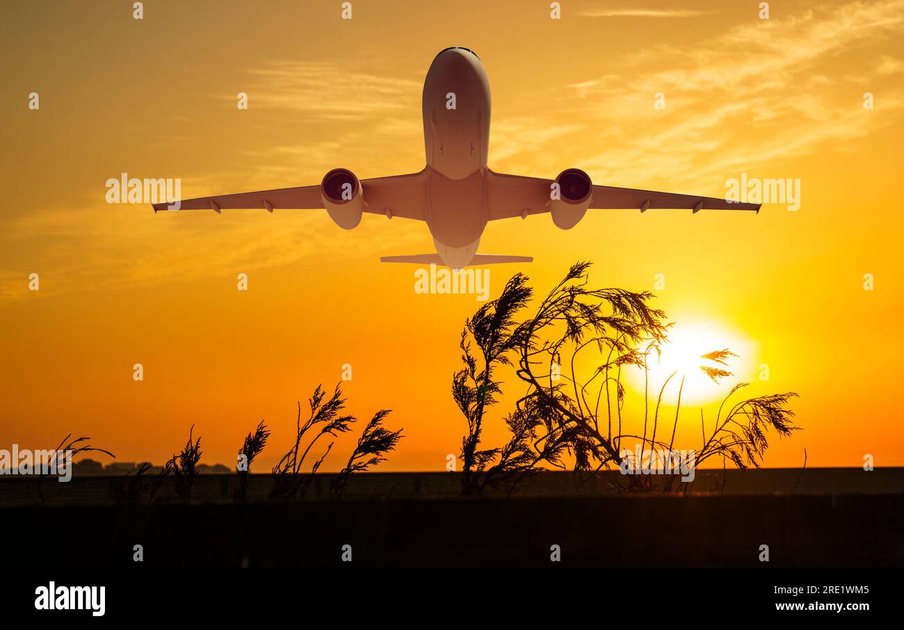 passenger plane fly up over take-off runway from airport at sunset, sunrise Stock Photo - Alamy