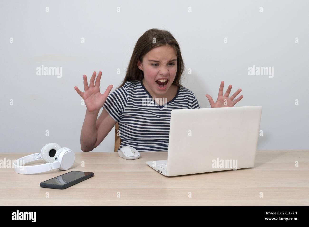 A Teenage Girl With A Computer Is Angry With An Interlocutor Online