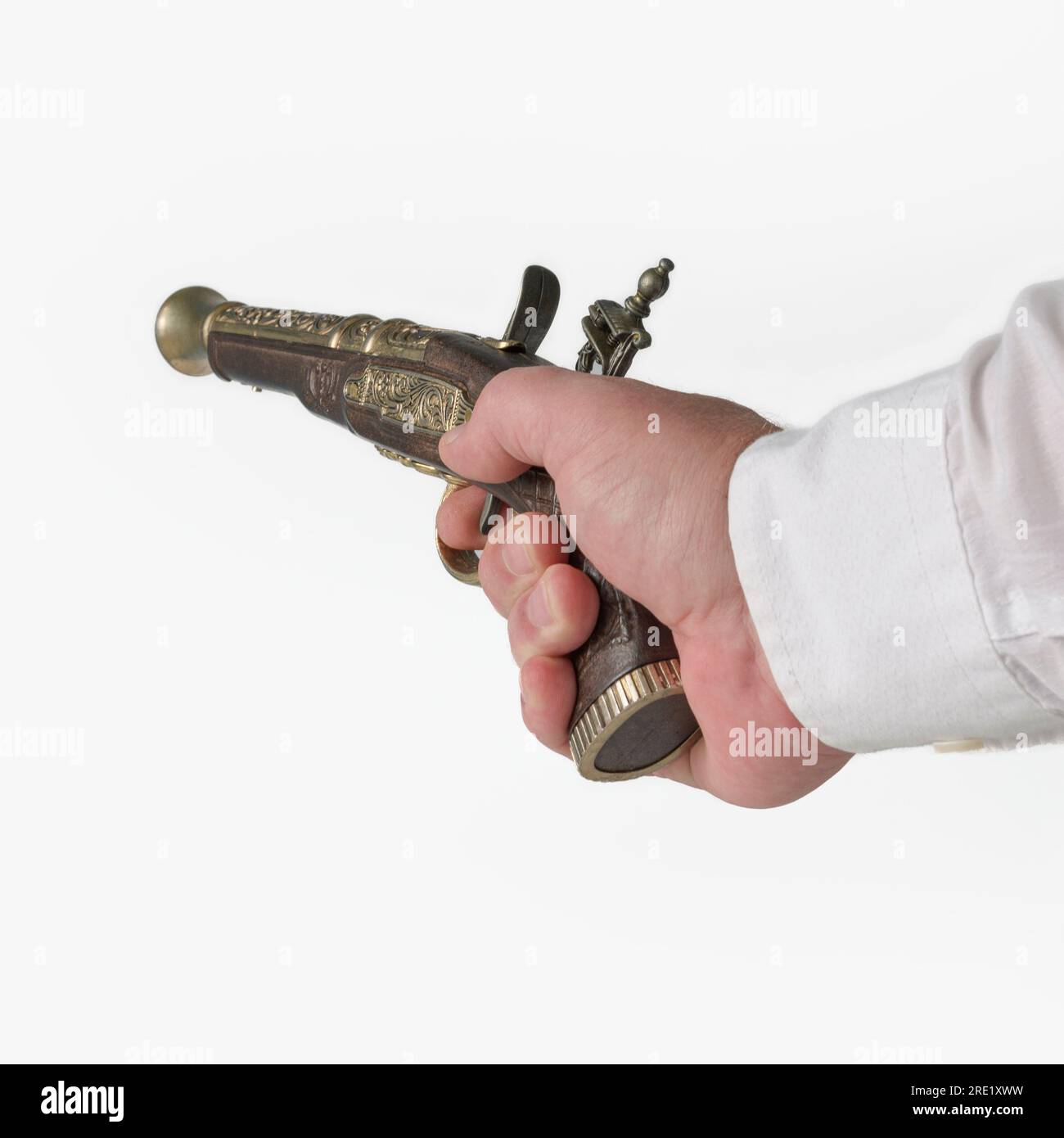 Hand with a vintage pistol. Imitation of an old pistol of the 18th ...